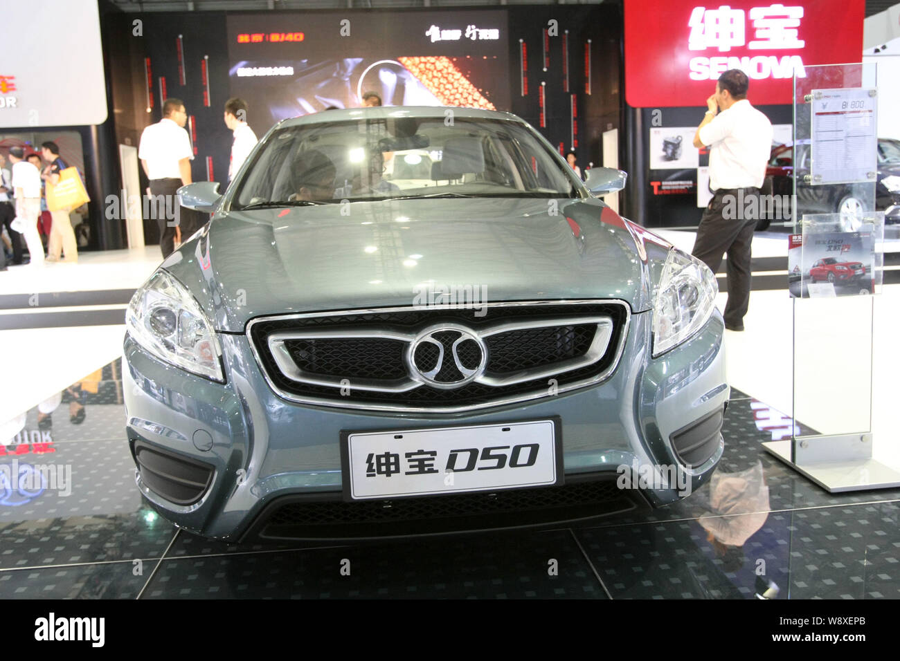 --FILE--A visitor tries out a Senova D50 of BAIC Motor during the 2014 ...