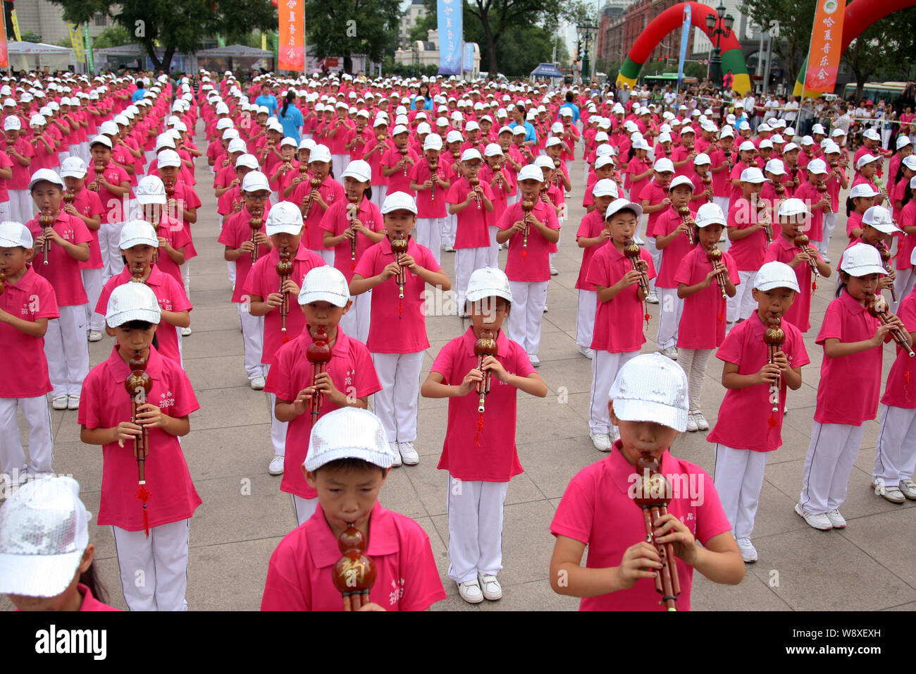 Local Chinese residents and young students play hulusi, a traditional ...