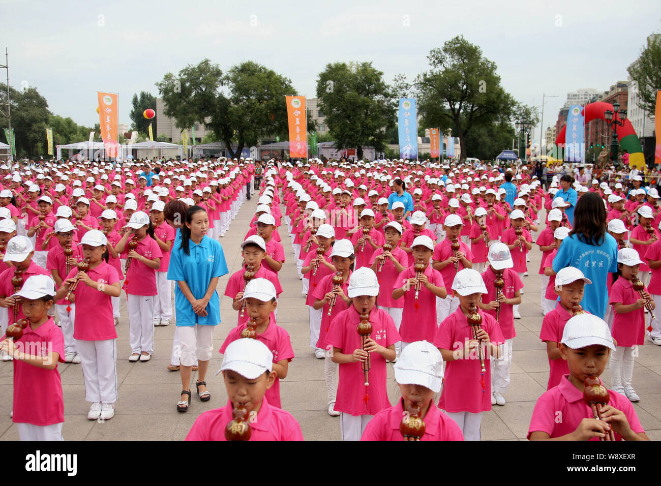 Local Chinese residents and young students play hulusi, a traditional ...