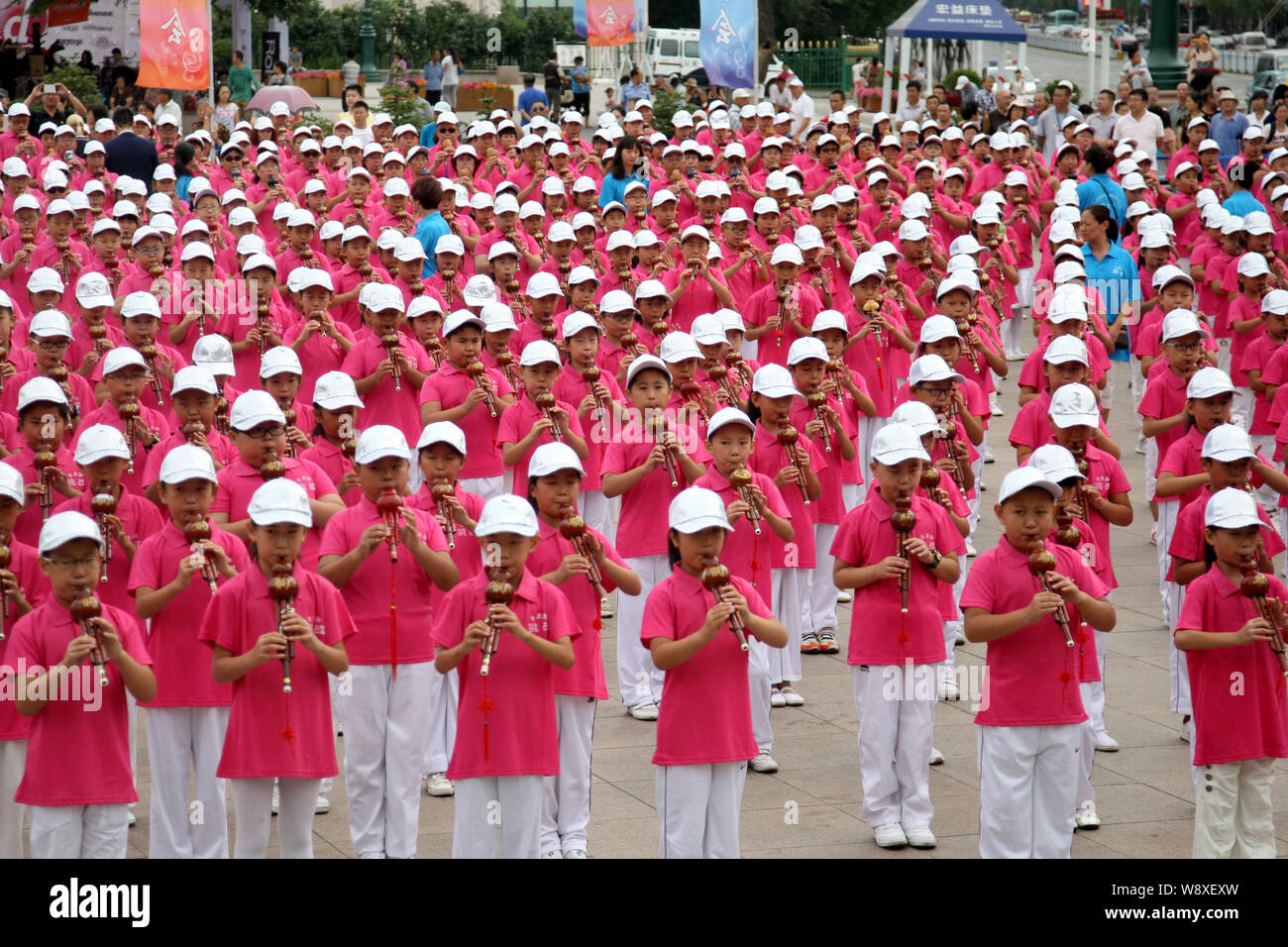 Local Chinese residents and young students play hulusi, a traditional ...