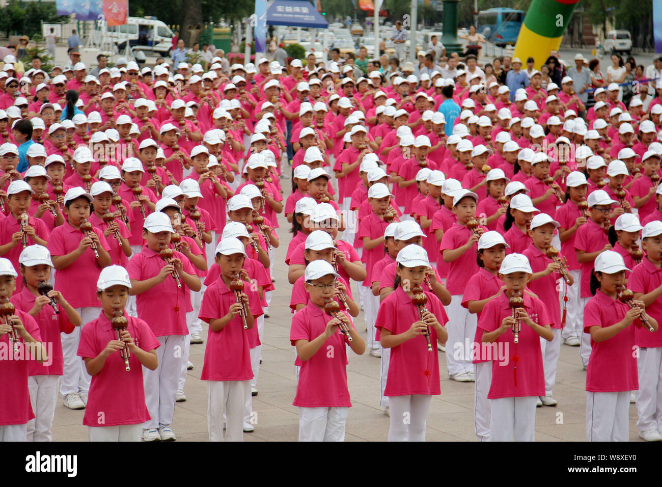 Local Chinese residents and young students play hulusi, a traditional ...
