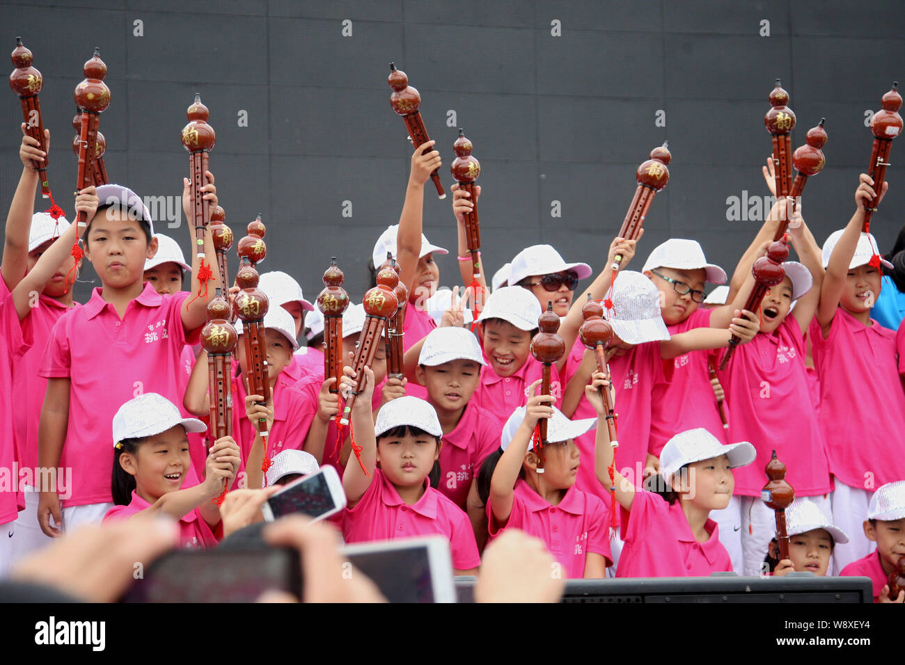 Young Chinese students hold up their hulusi, a traditional Chinese free ...