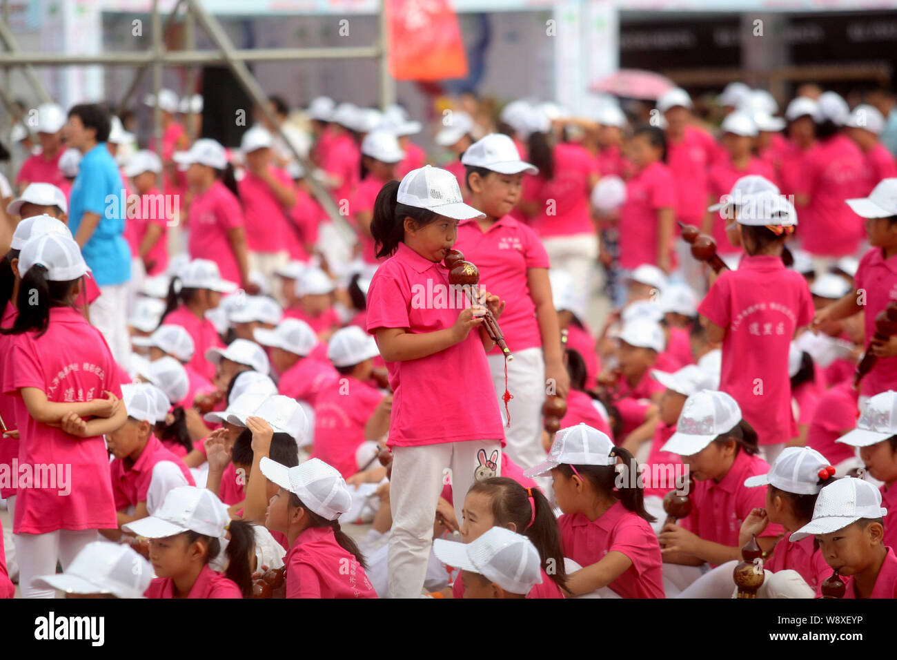 Young Chinese students warm up before playing hulusi, a traditional ...