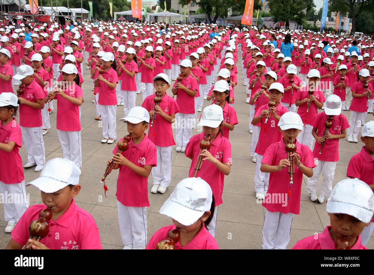 Local Chinese residents and young students play hulusi, a traditional ...