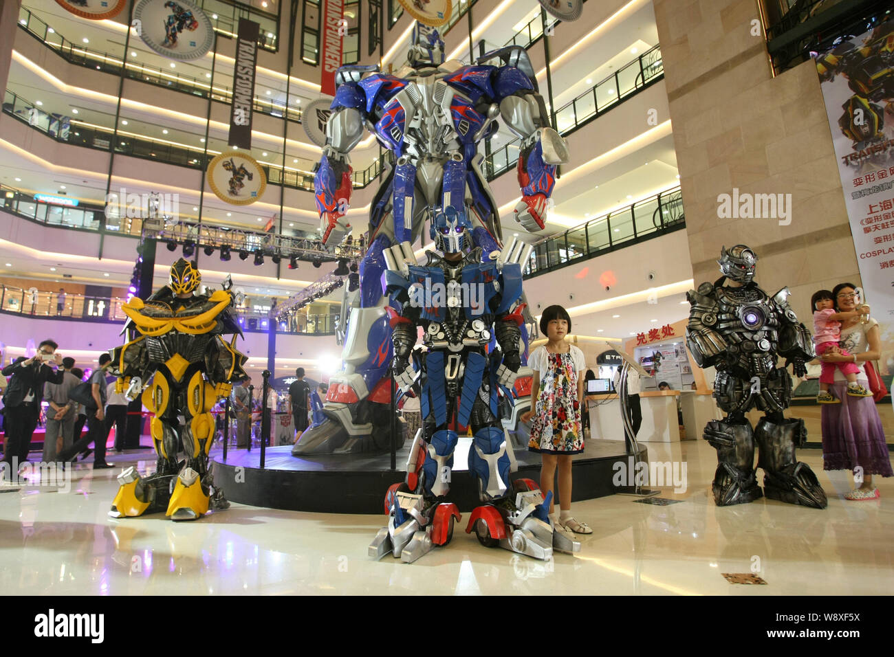 Three performers dressed in their Transformers costumes pose in front ...