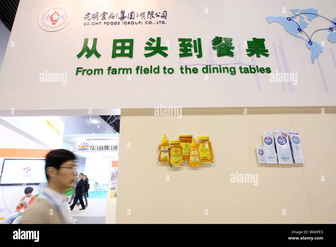 --FILE--A visitor walks past the stand of Bright Food (Group) Co., Ltd ...