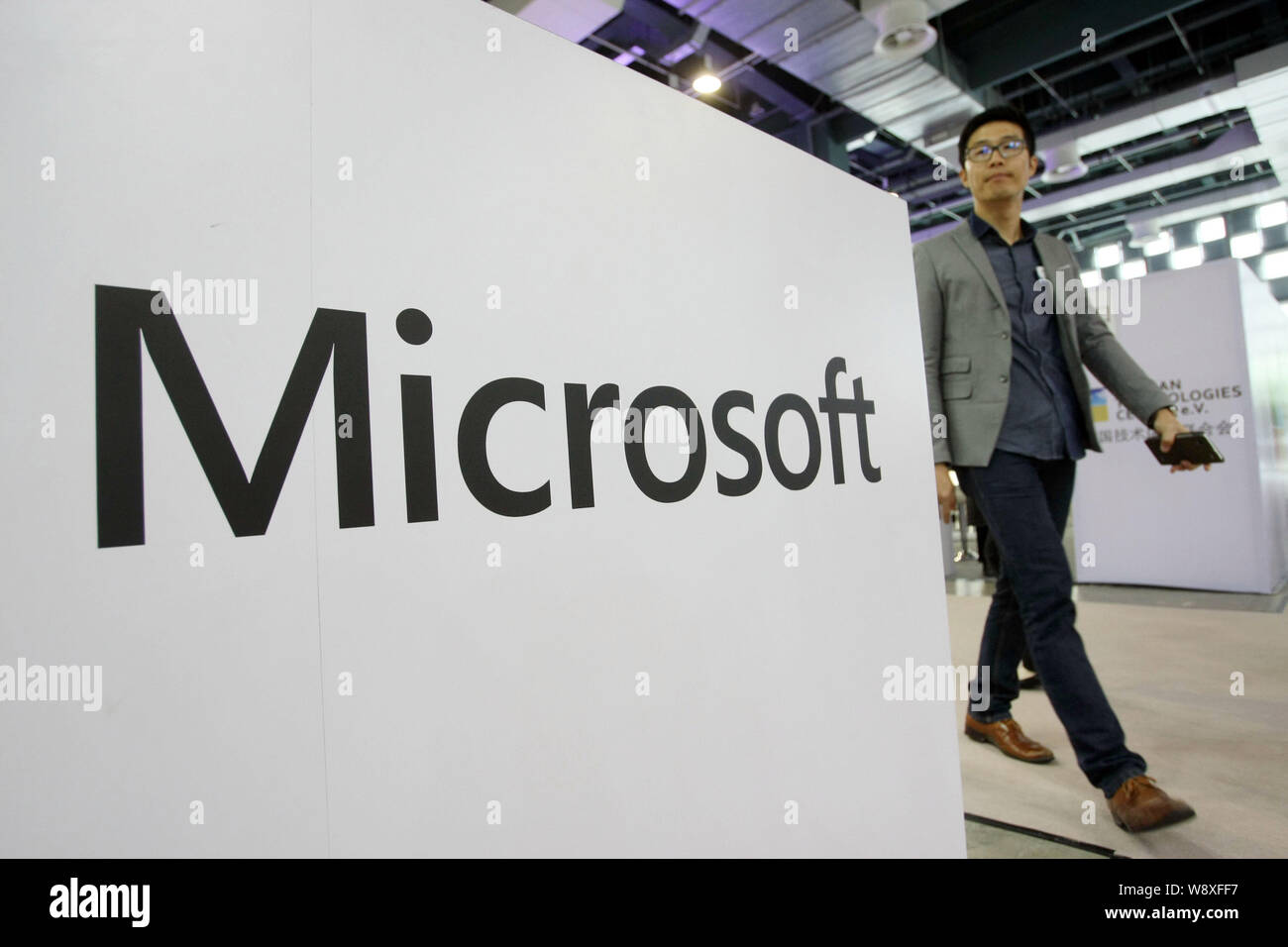 --FILE--A visitor walks past at the stand of Microsoft during the 2nd ...