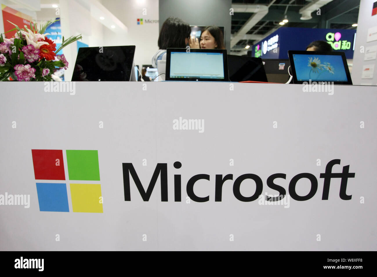 --FILE--Employees are seen at the stand of Microsoft during the 2nd ...