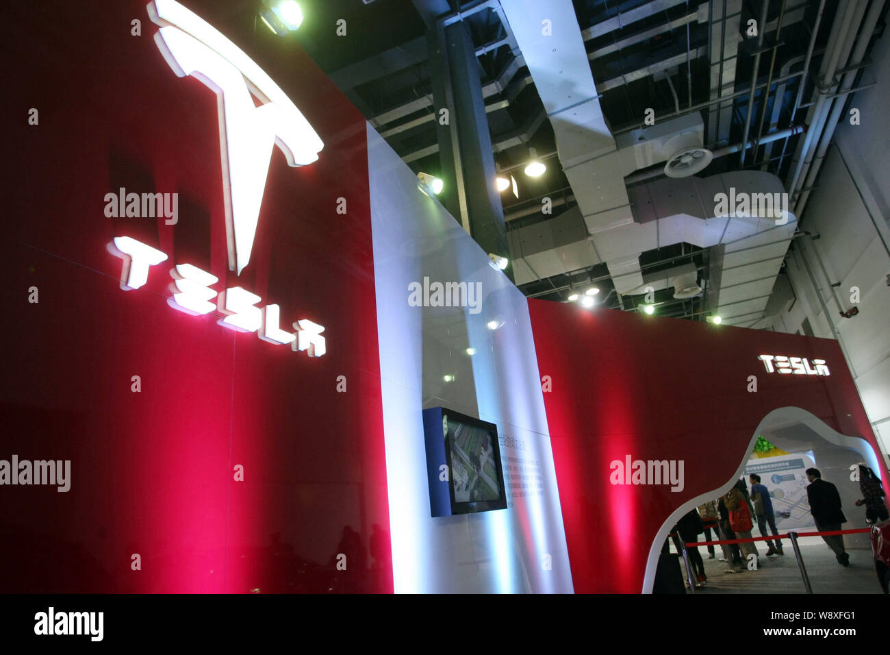 --FILE--People visit the stand of Tesla during the 2nd China (Shanghai ...