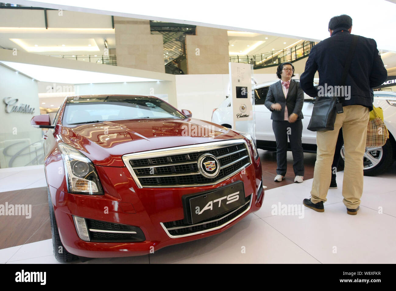 --FILE--Visitors view Cadillac cars of General Motors (GM) on display ...