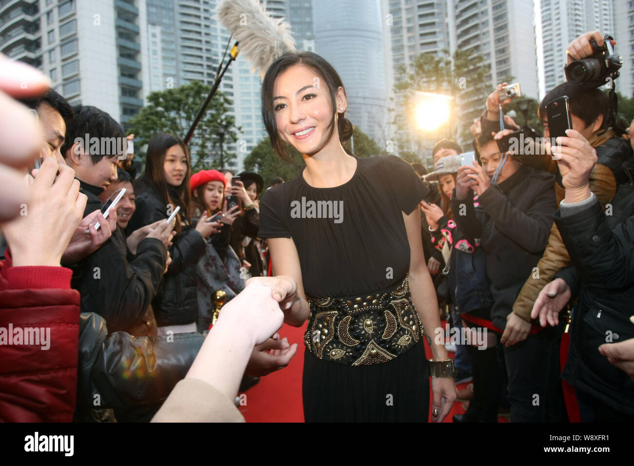 Hong Kong singer and actress Cecilia Cheung shakes hands with a fan on ...