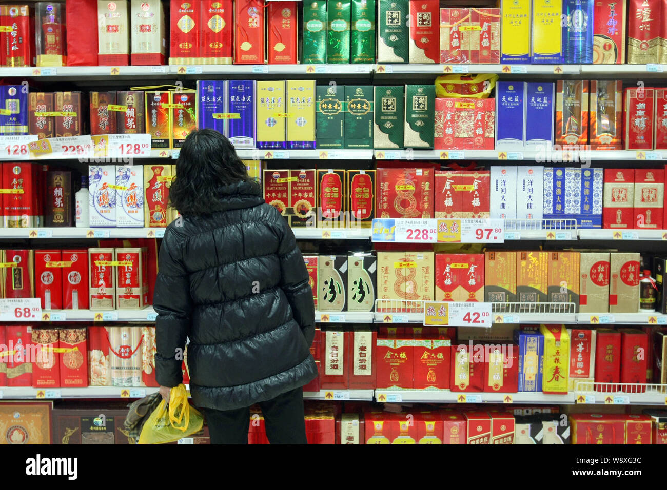 --FILE--A customer shops for baijiu or distilled liquor at a supermarket in Shanghai, China, 25 ...
