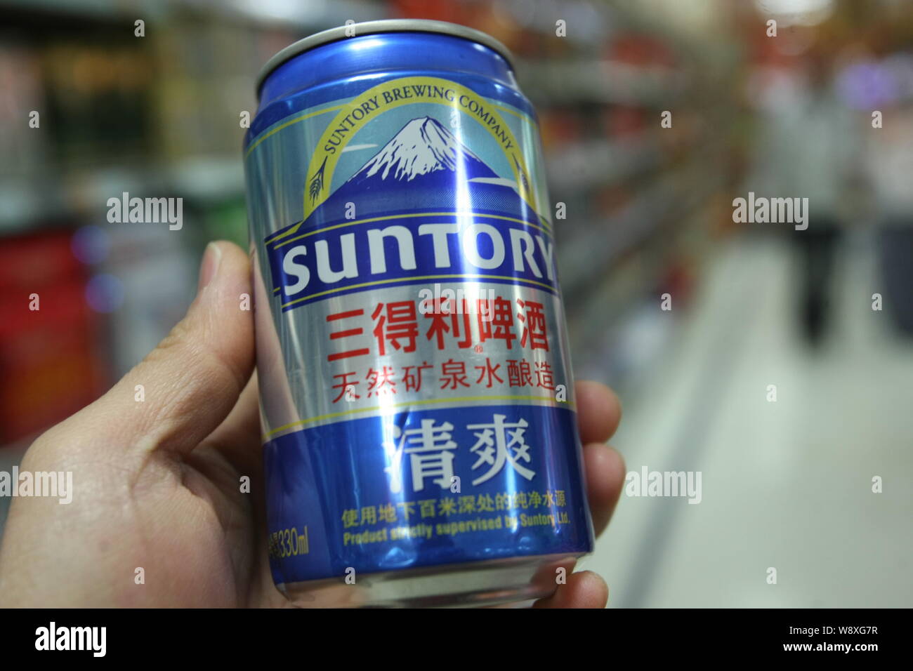 --FILE--A customer buys a can of Suntory beer at a supermarket in ...