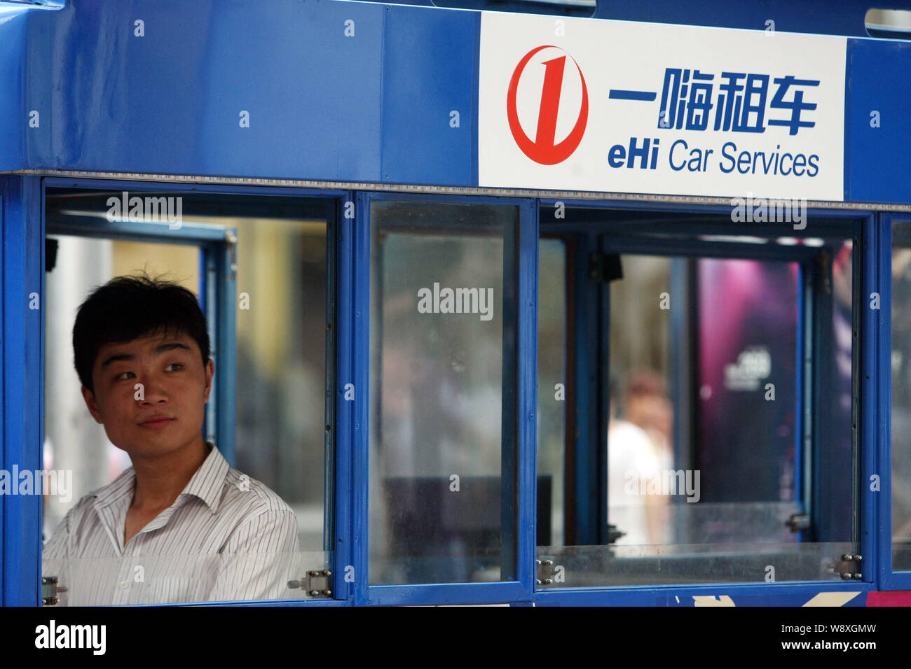 --FILE--A tourist sits in a sightseeing car with an advertisement of ...