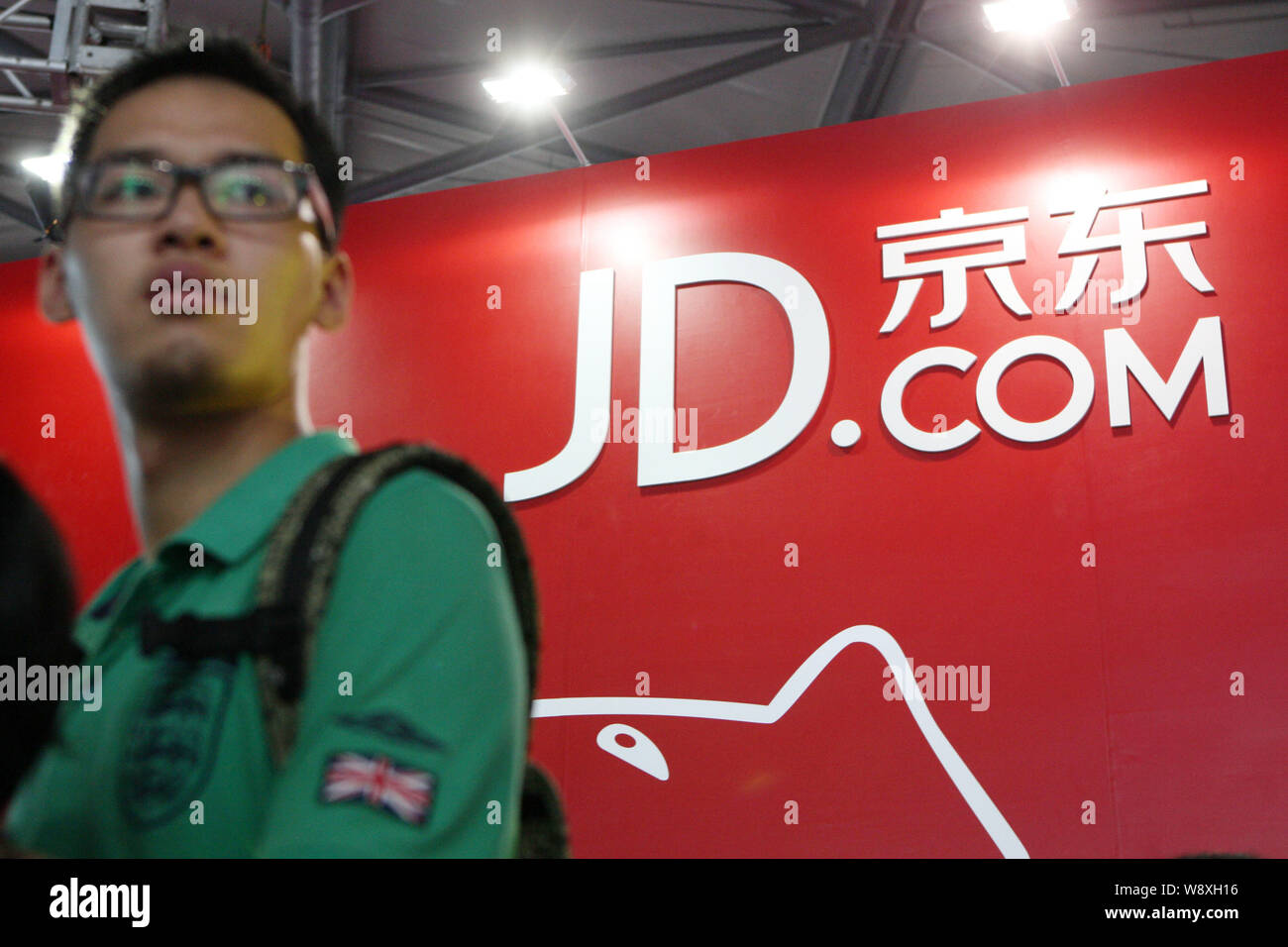 --FILE--A customer walks past an advertisement for online shopping site ...