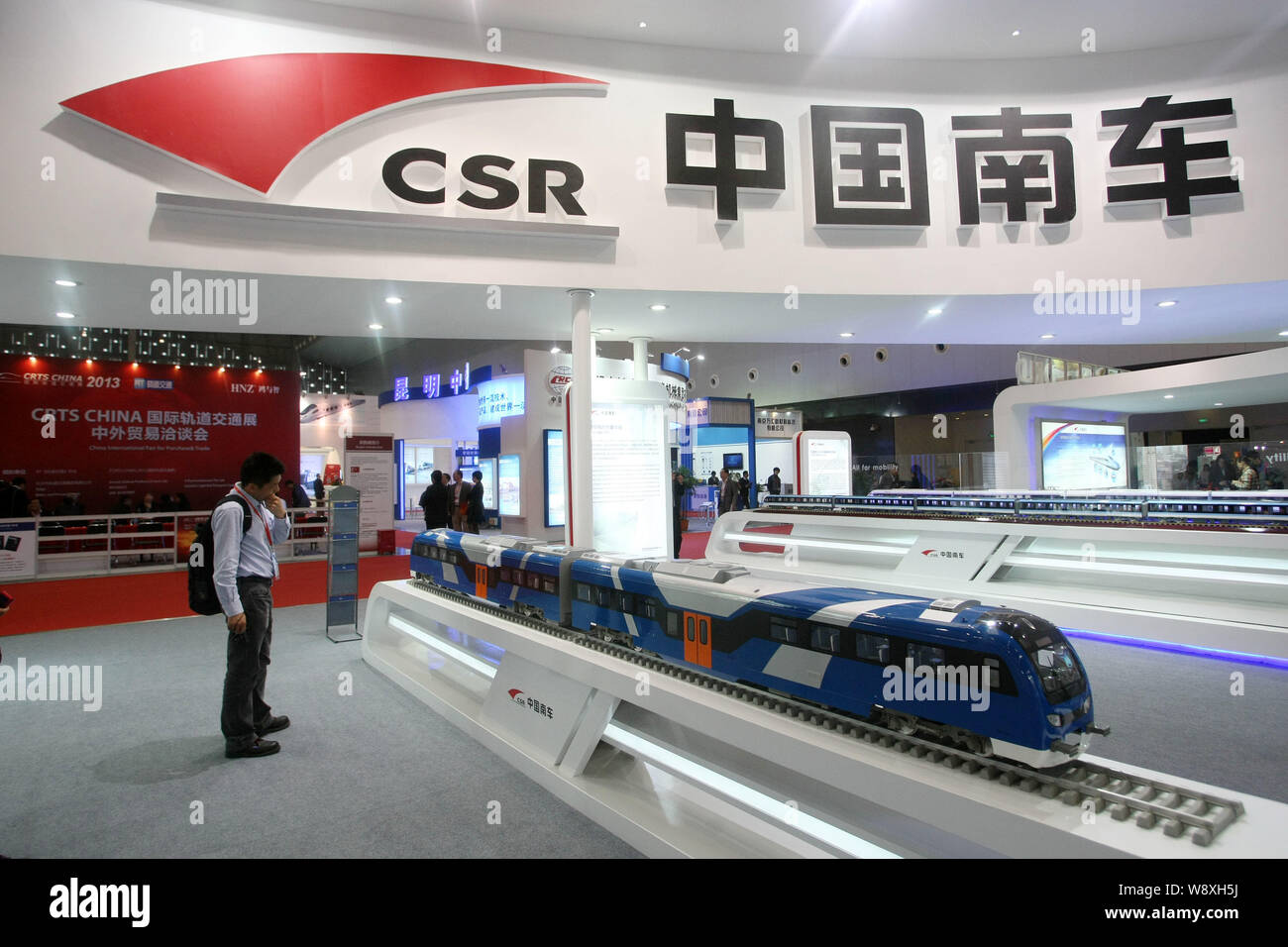 --FILE--A visitor looks at a model of a train at the stand of CSR ...