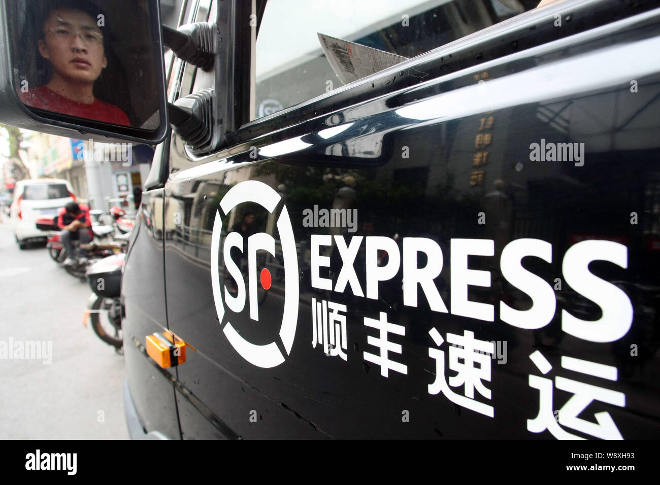 --FILE--A Chinese employee drives a van of S.F. Express in Shanghai ...