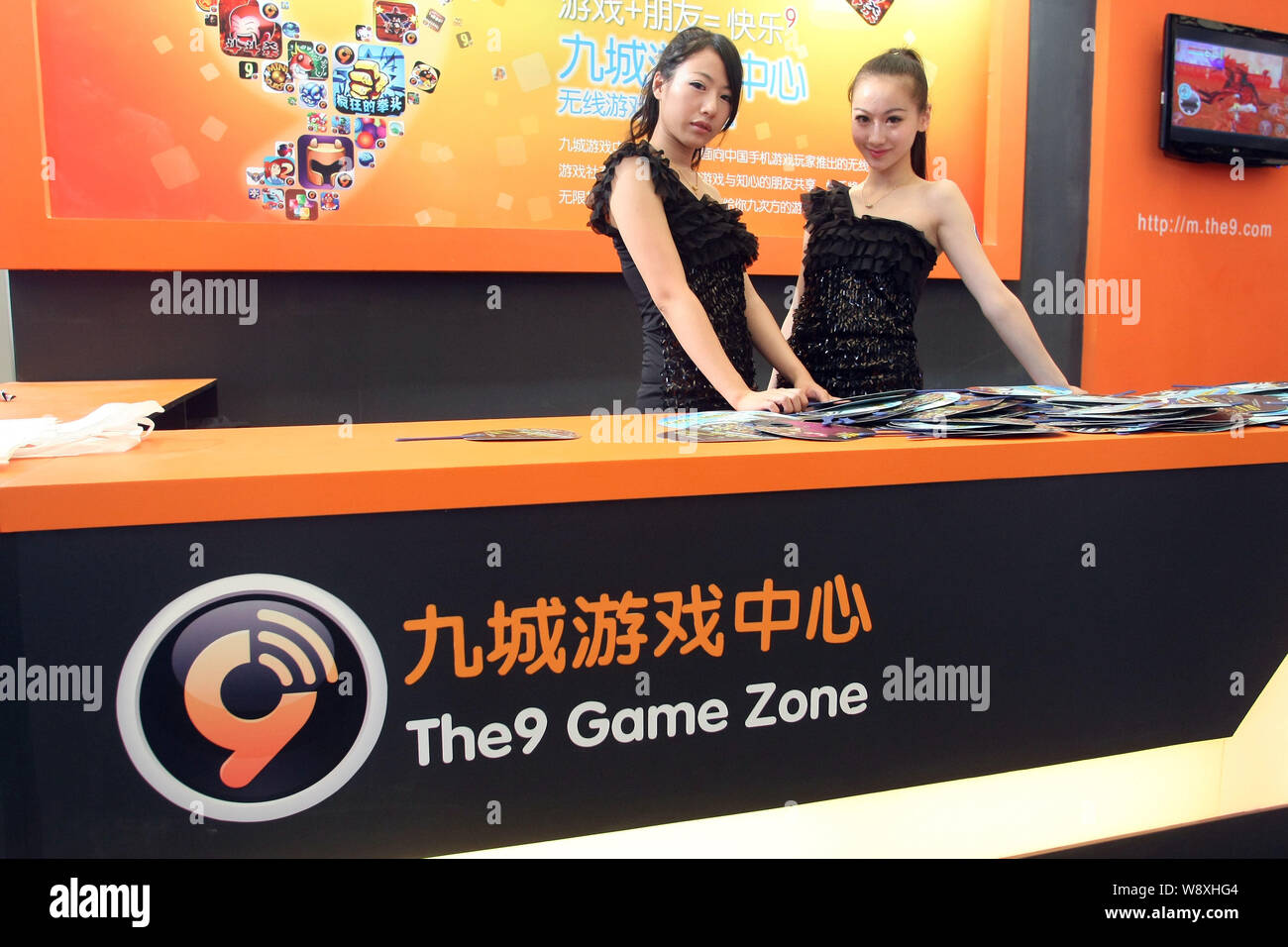 --FILE--Showgirls pose at the stand of The9 Game Zone during the 9th China Digital Entertainment ...