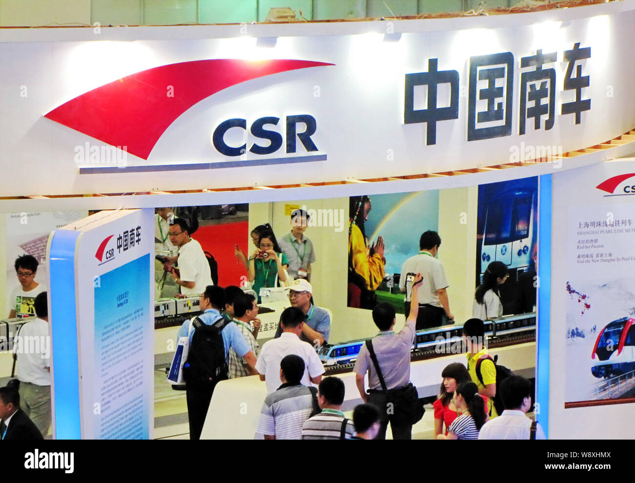 --FILE--Visitors view models of subway trains at the stand of CSR ...