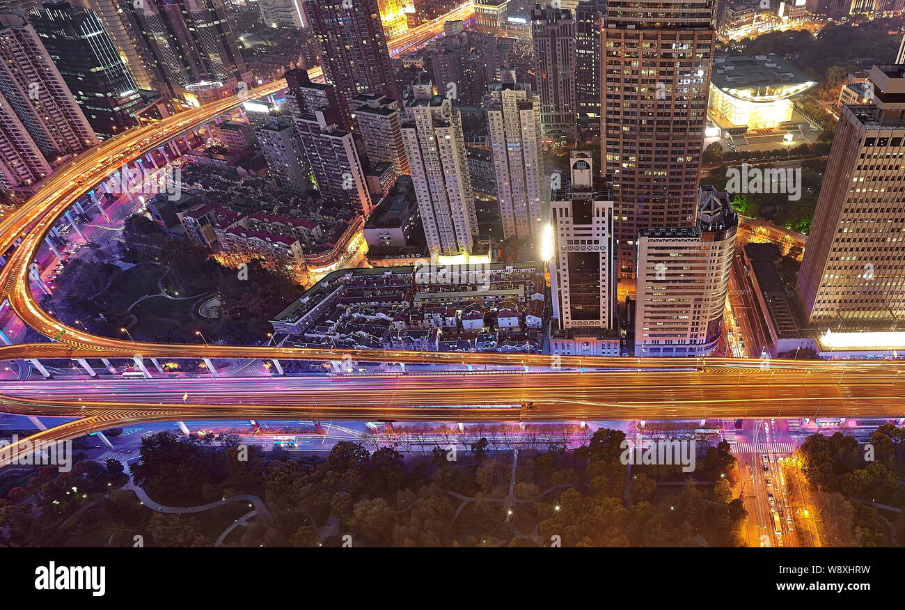 --FILE--Night view of busy traffic on elevated highways next to high ...