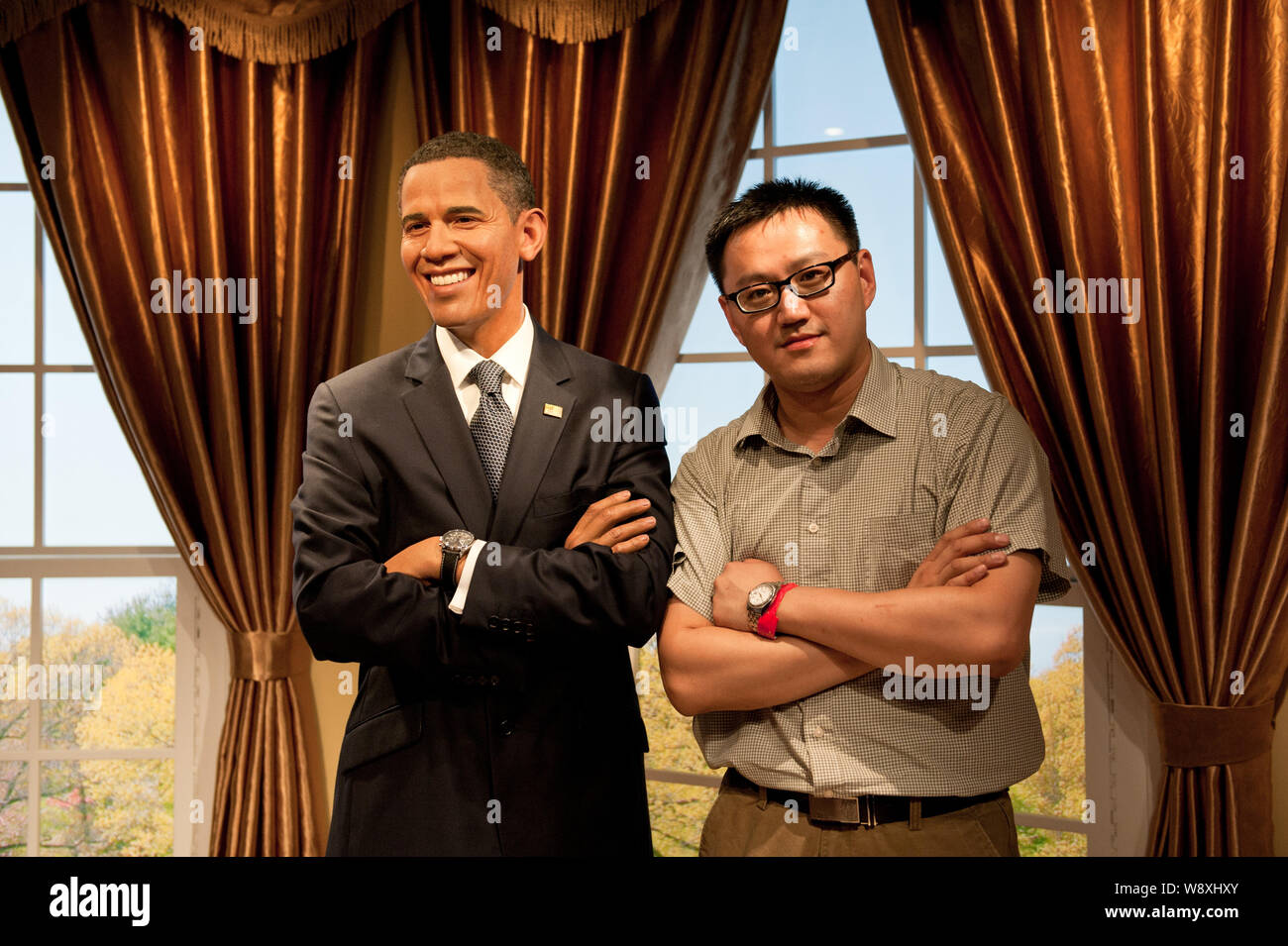 A visitor poses with the wax statue of U.S. President Barack Obama at ...