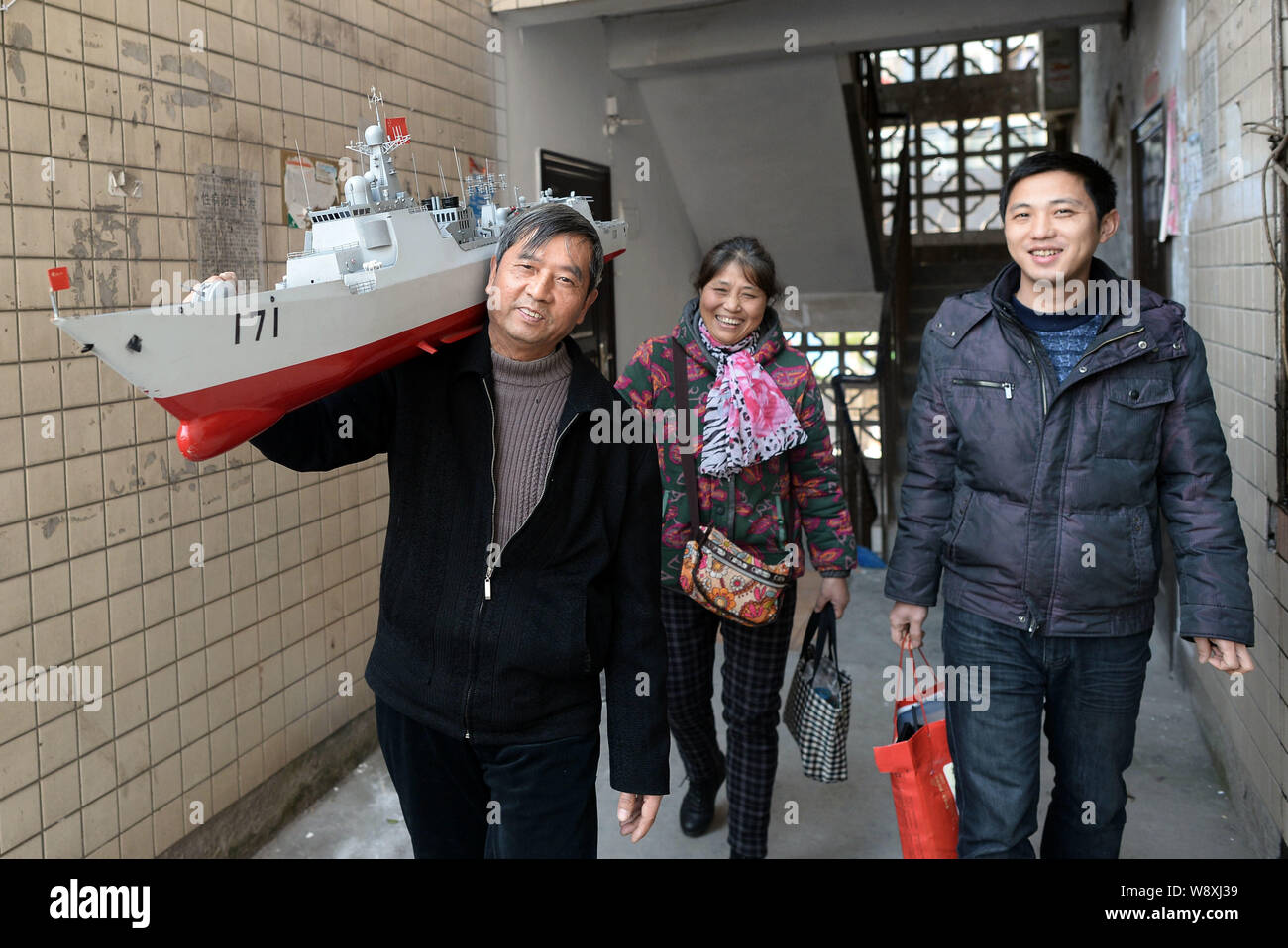 Retired Chinese man Wang Xuanhua, left, walks with his families as he ...