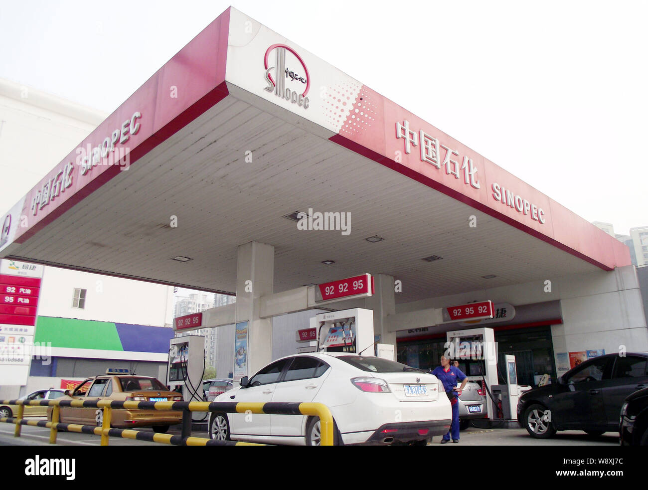 --FILE--Cars queue up to be refueled at a gas station of Sinopec in ...