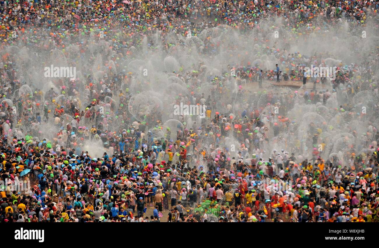 Crowds of local people splash water to celebrate the New Year of Dai ...