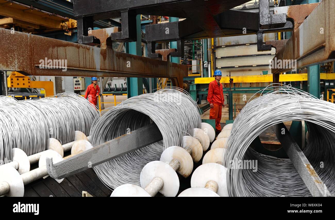 --FILE--Chinese workers survey the production of stainless steel wire ...