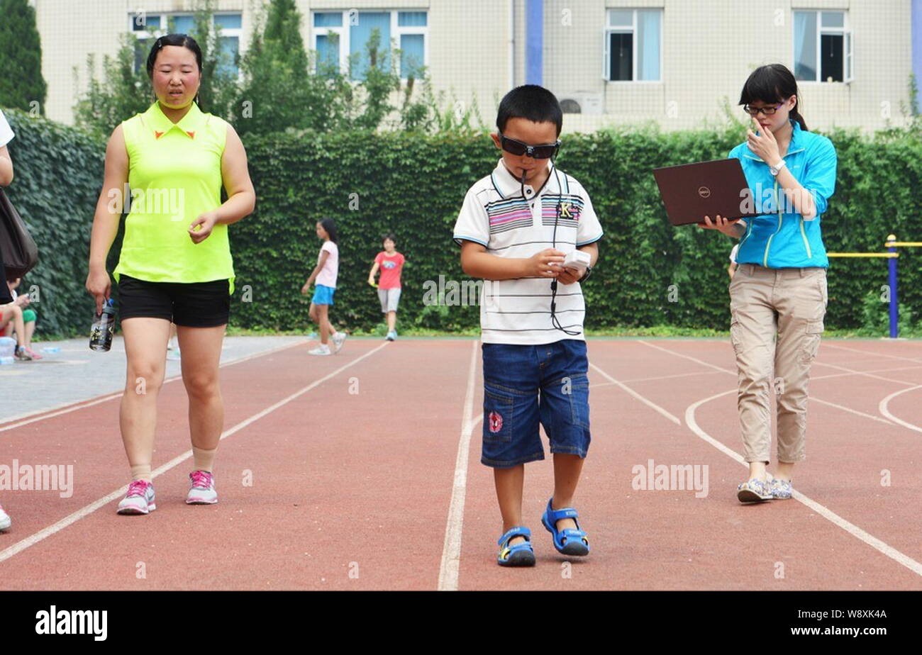 7-year-old Chinese boy Guo Bin, center, nicknamed Bin Bin, whose eyes ...
