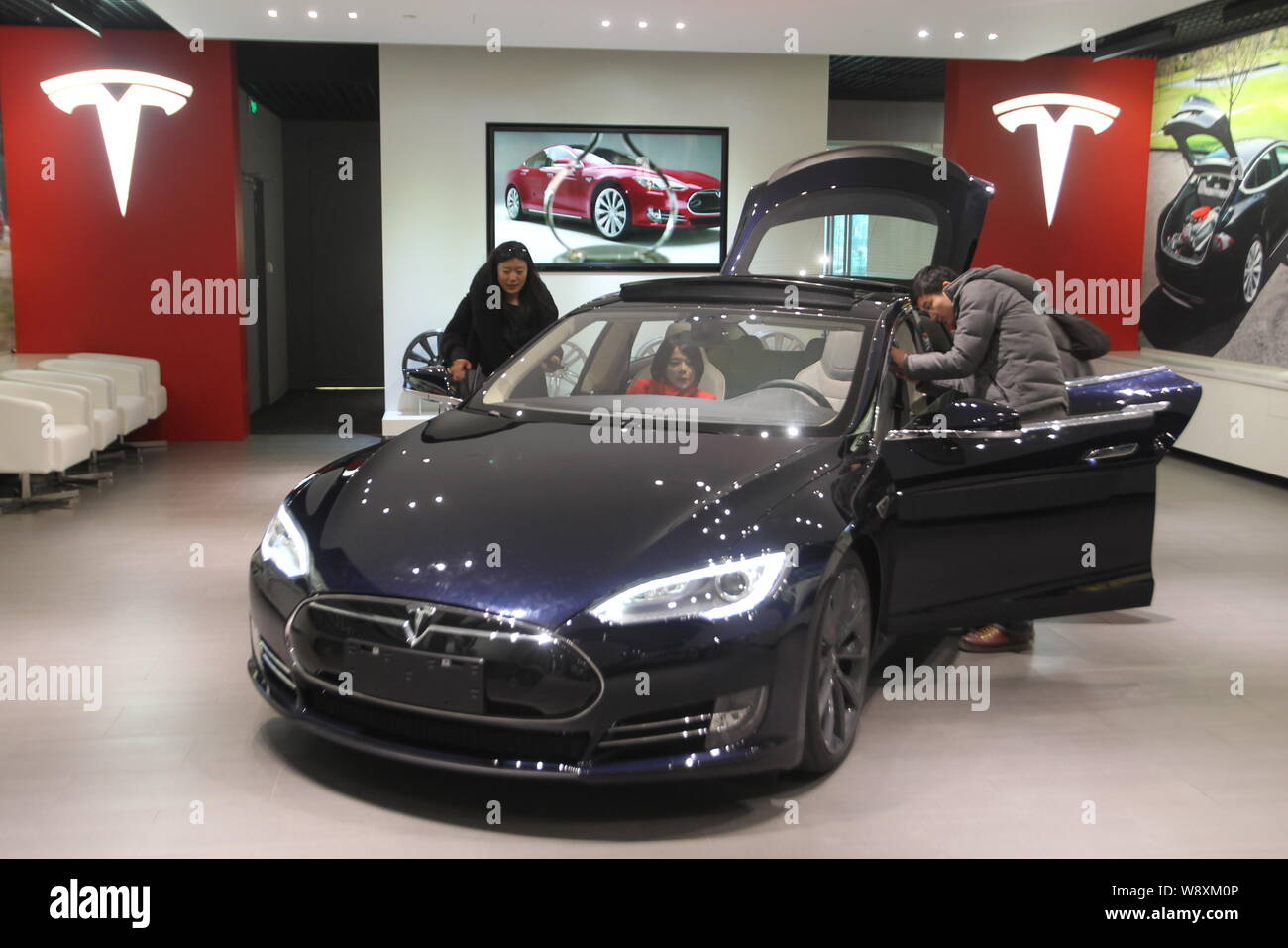 --FILE--Visitors look at a Model S electric car on display at the Tesla ...