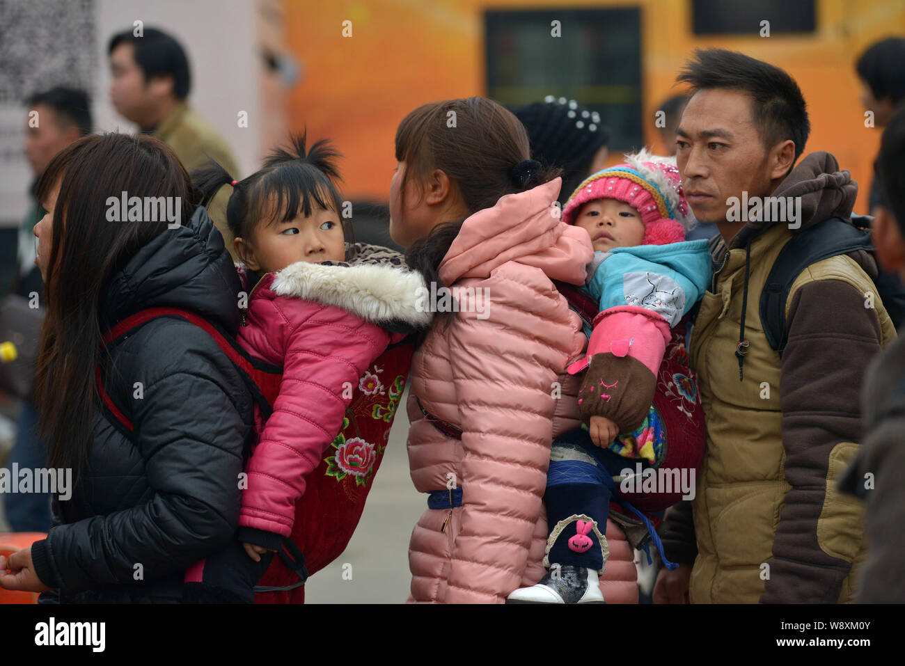 Chinese migrant workers carry their young kids when they and other ...