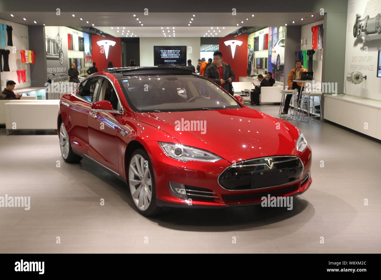 --FILE--A visitor looks at a Model S electric car on display at the ...