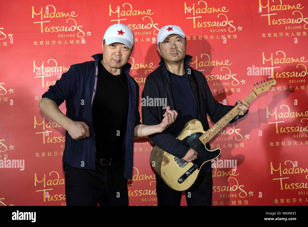 Chinese singer-songwriter Cui Jian, left, poses with the wax figure of ...