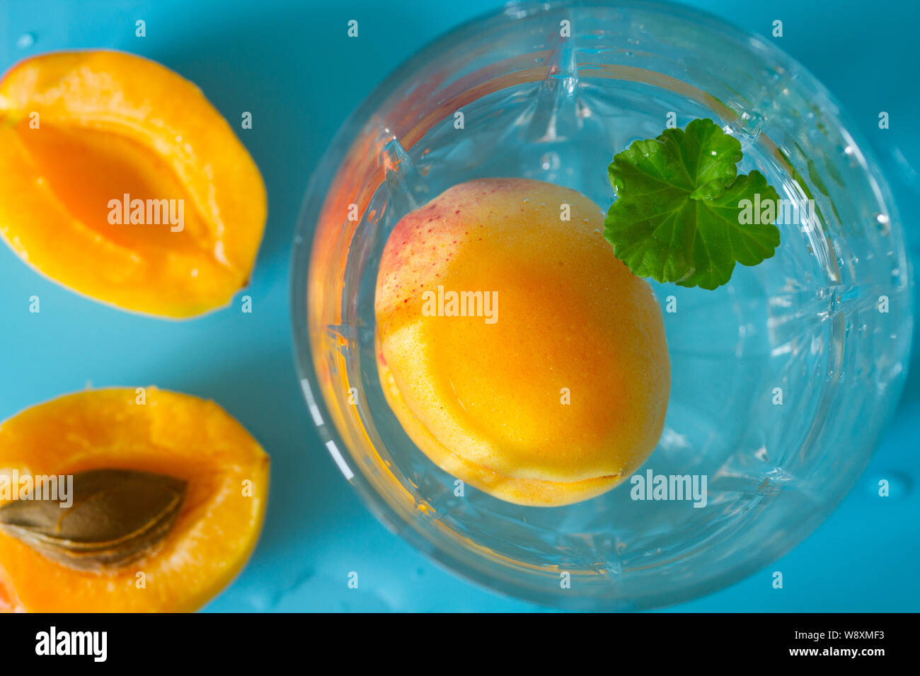 ripe apricots on the blue background. natural light Stock Photo - Alamy