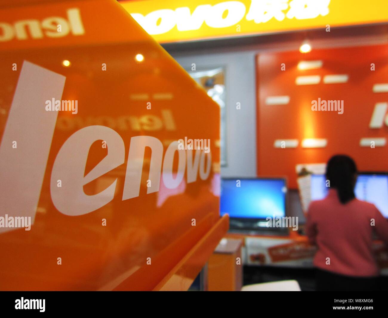 --FILE--A young girl tries out a desktop computer at a store of Lenovo ...