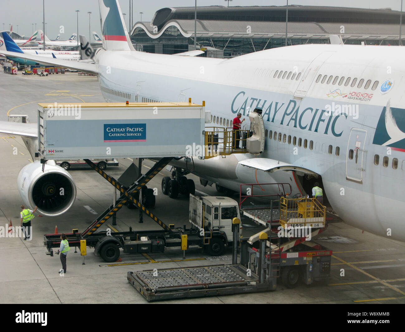 --FILE--Ground crew members load cargo onto a plane of Cathay Pacific ...