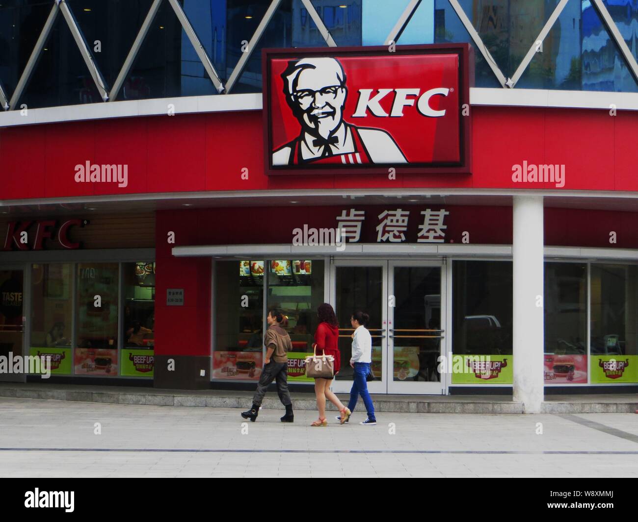 --FILE--Pedestrians walk past a KFC fastfood restaurant of Yum Brands ...