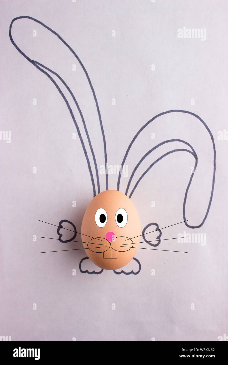 Eggs on white background with bunny ears and face Stock Photo - Alamy