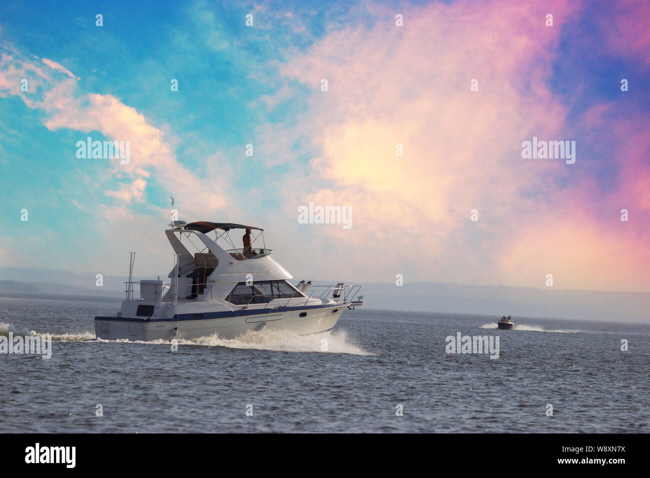 Luxury motor boat. Pink clouds in the sky Stock Photo - Alamy