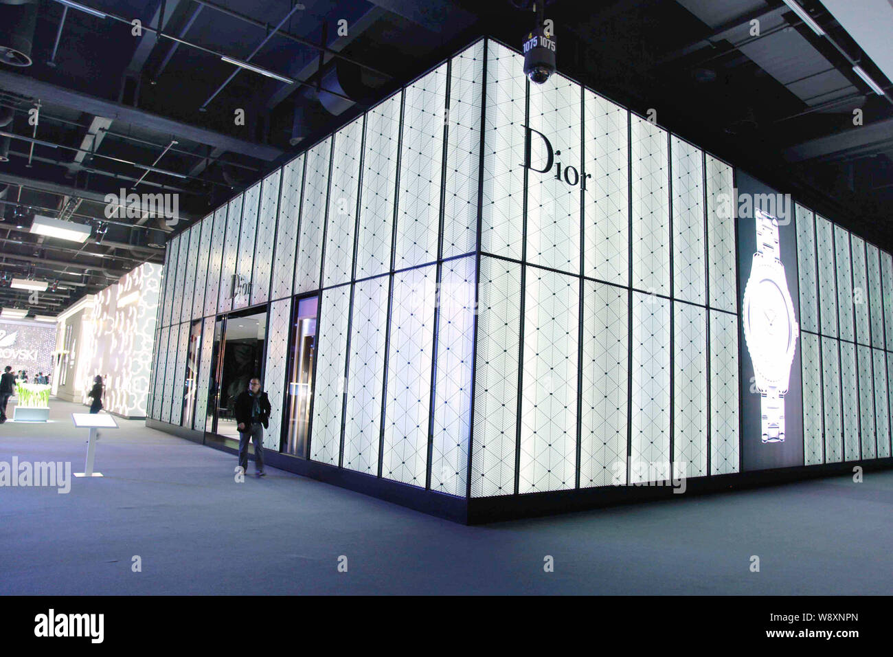 Visitors walk past the stand of Dior during the Baselworld Watch and ...