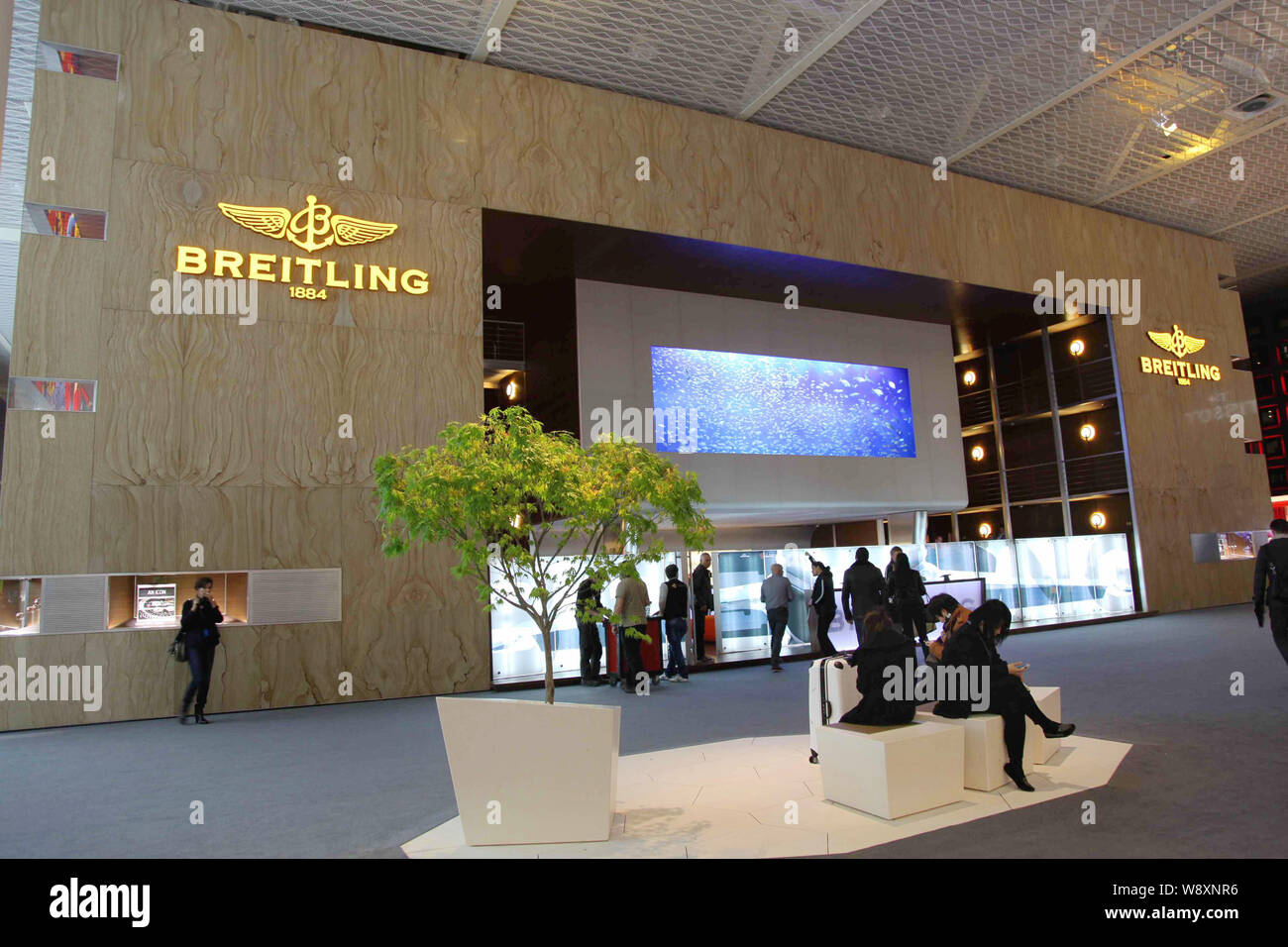 People visit the stand of Breitling during the Baselworld Watch and ...