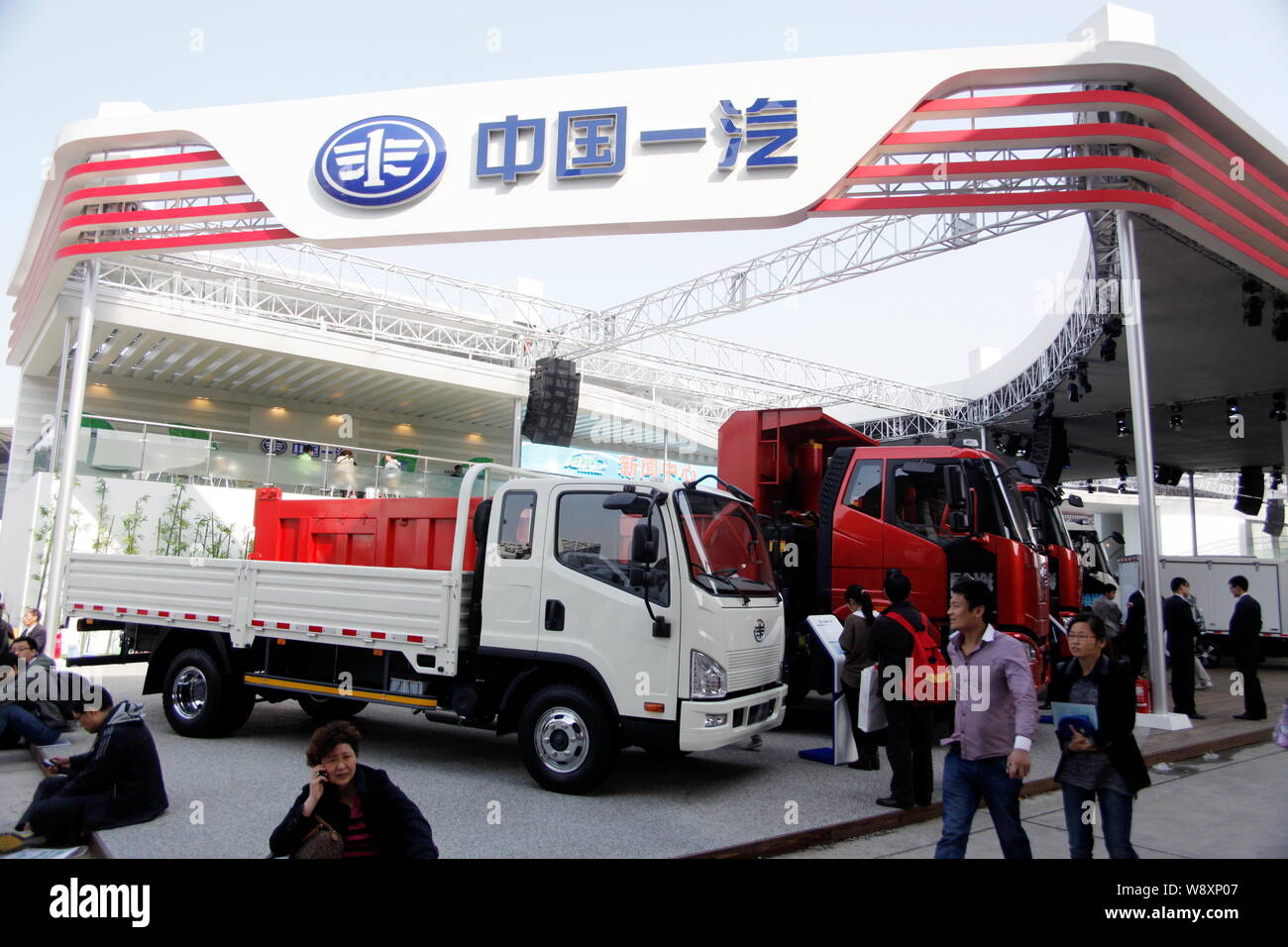 --FILE--Visitors look at trucks of FAW during the 15th Shanghai ...