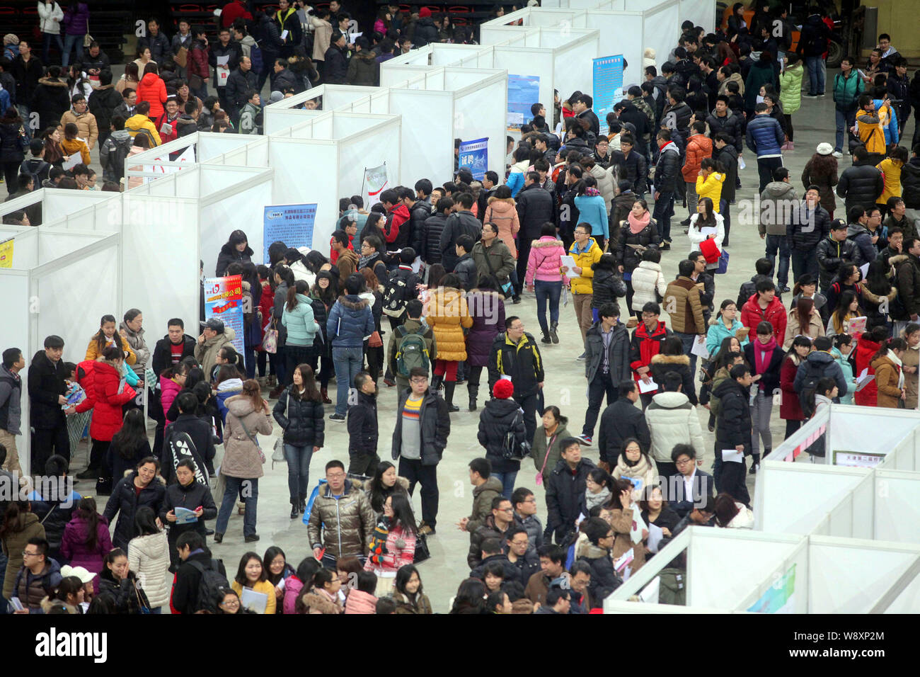 Chinese graduates crowd stalls at a job fair in Tianjin, China, 9 ...