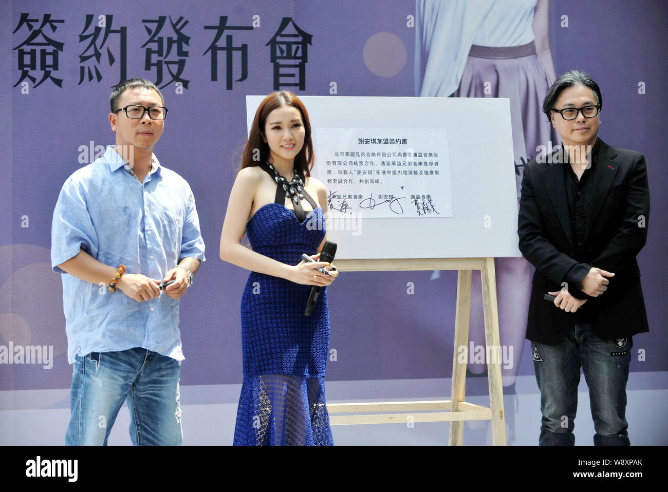 Hong Kong singer and actress Kay Tse, center, poses during a signing ...