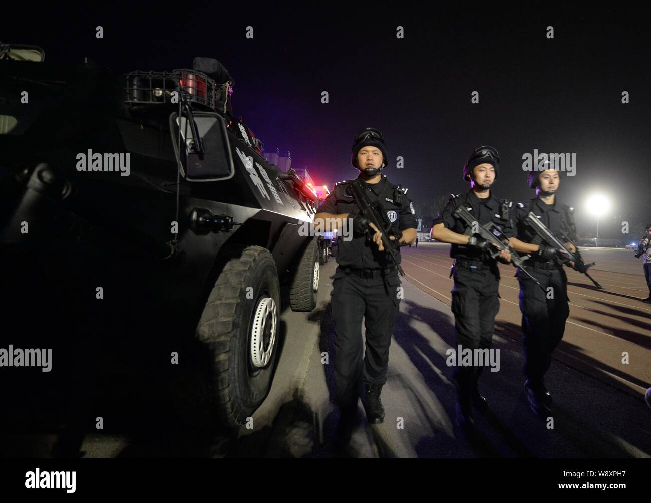 Special police officers armed with guns patrol a street in Beijing ...