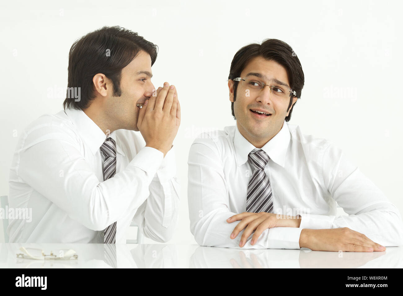 Multiple images of a businessman gossiping in an office Stock Photo - Alamy