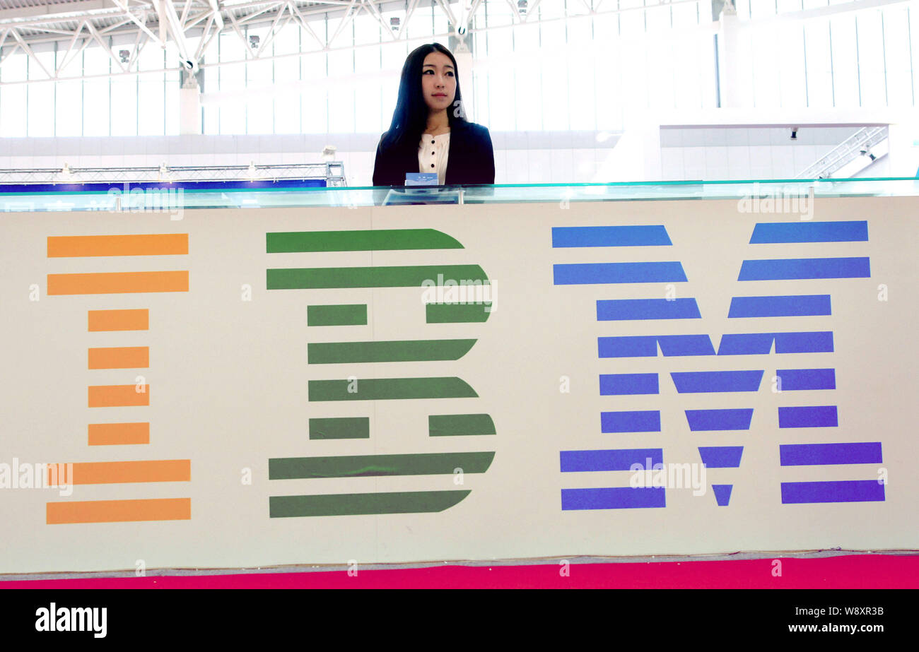 --FILE--A Chinese employee is seen at the stand of IBM during an ...