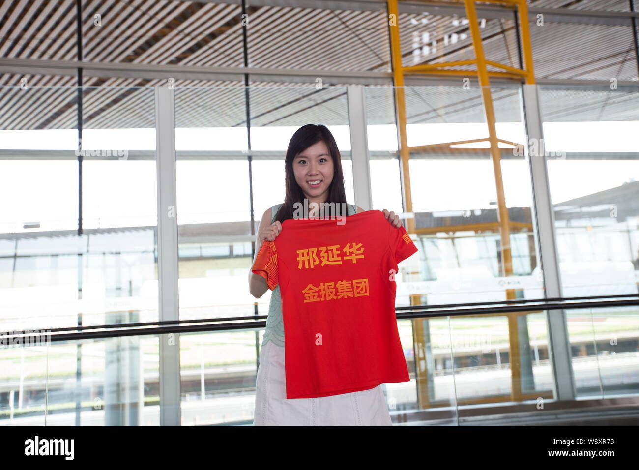 American table tennis player Ariel Hsing shows her jersey of Jinhua ...