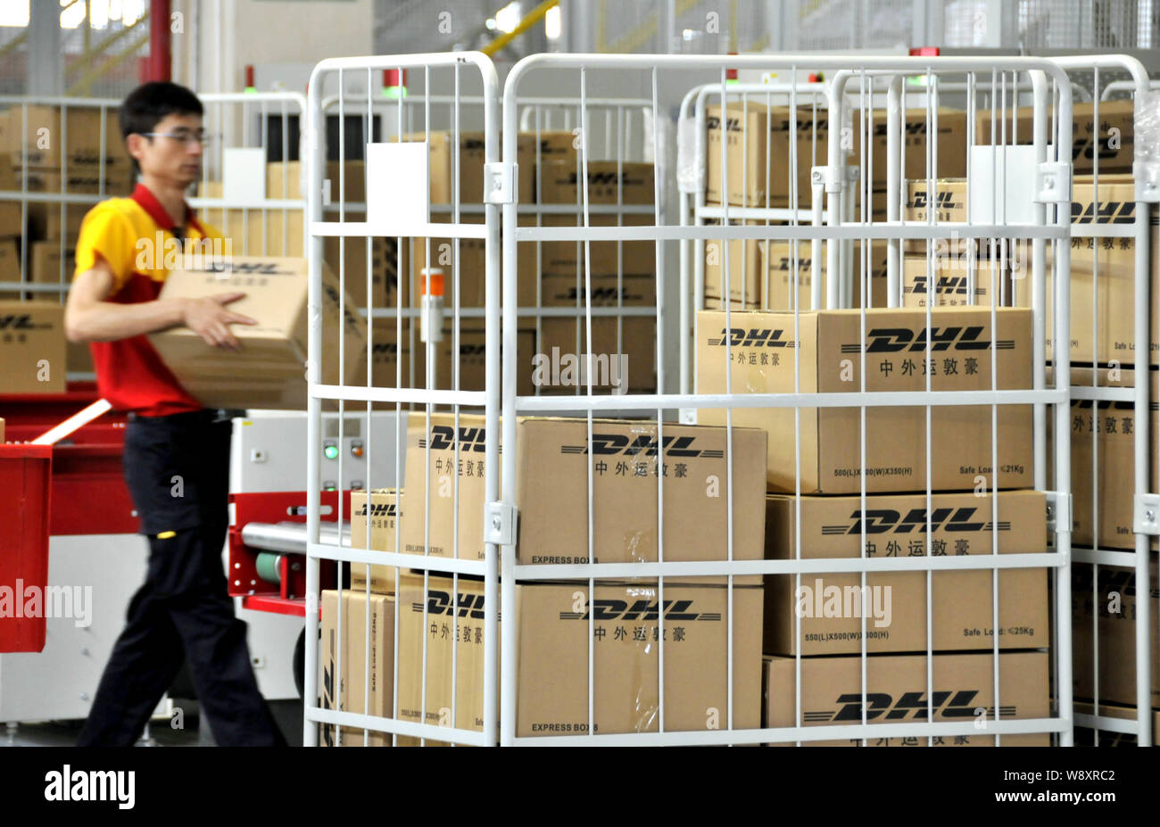 --FILE--Chinese workers put sort parcels during a test at the new DHL ...